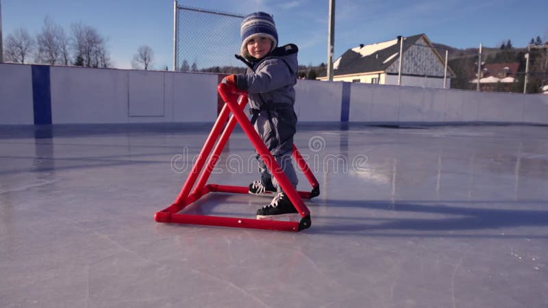 Toddler Learning Ice Skating with Support Frame Slow Motion Stock ...