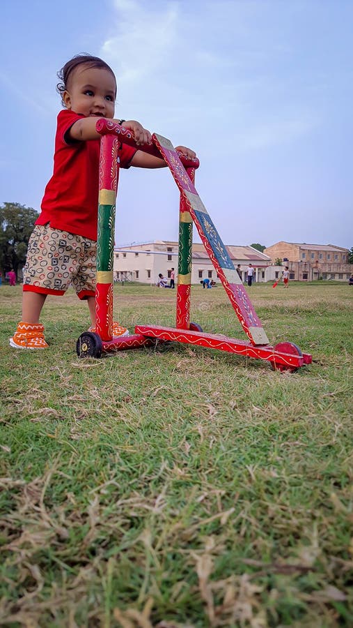 Toddler Learning Walking on Traditional Wood Walker at Outdoor from ...