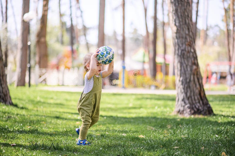 Toddler Playing with a Ball in a Sunny Park. Stock Photo - Image of ...