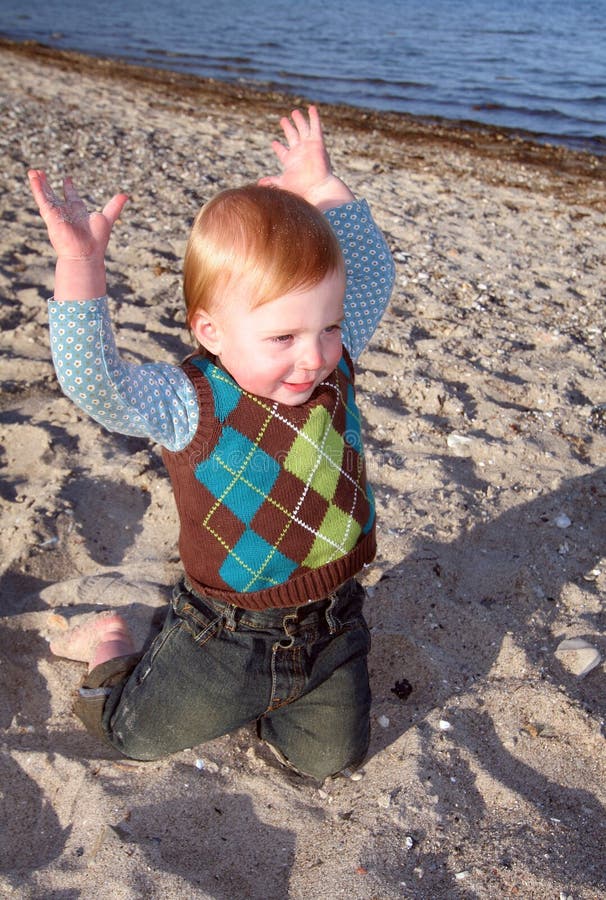 Toddler playing on beach stock photo. Image of sandy, beachfront - 2396308