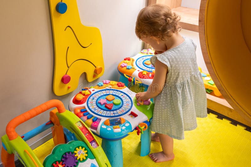 Toddler Playing with Colorful Educational Table in Playroom. Concept of ...