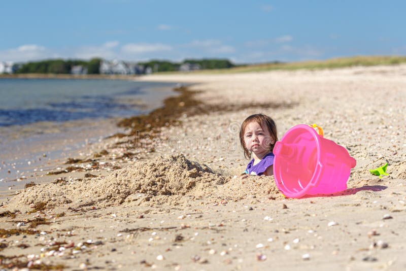 Toddler Playing and Digging in Sand at Beach, Sitting in Hole with Head ...