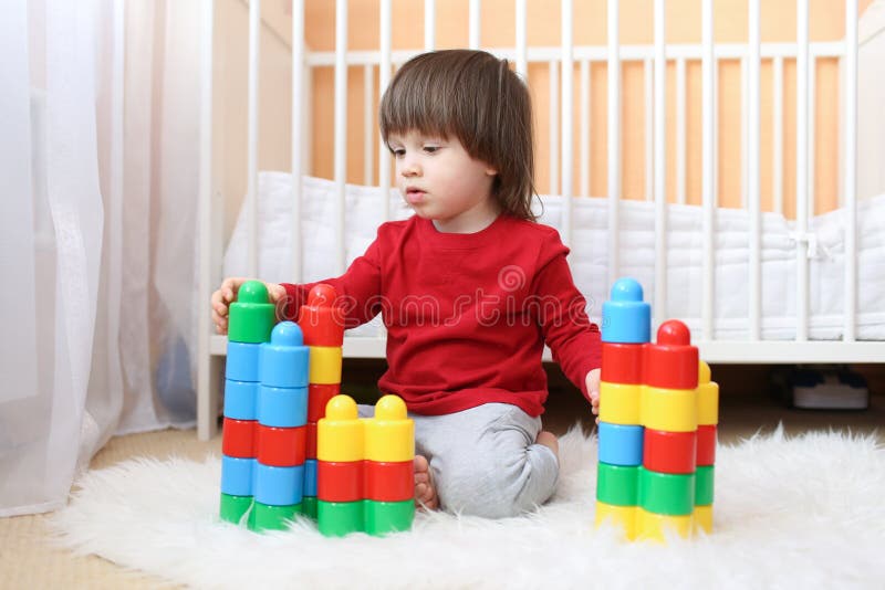 Toddler Playing Plastic Blocks Stock Photo - Image of home, sitting ...
