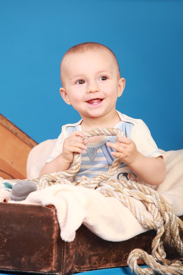 Toddler Playing with a Rope Sitting on a Blue Background Stock Image ...