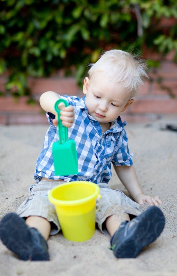 Toddler playing in sandbox stock image. Image of sunny - 19785249