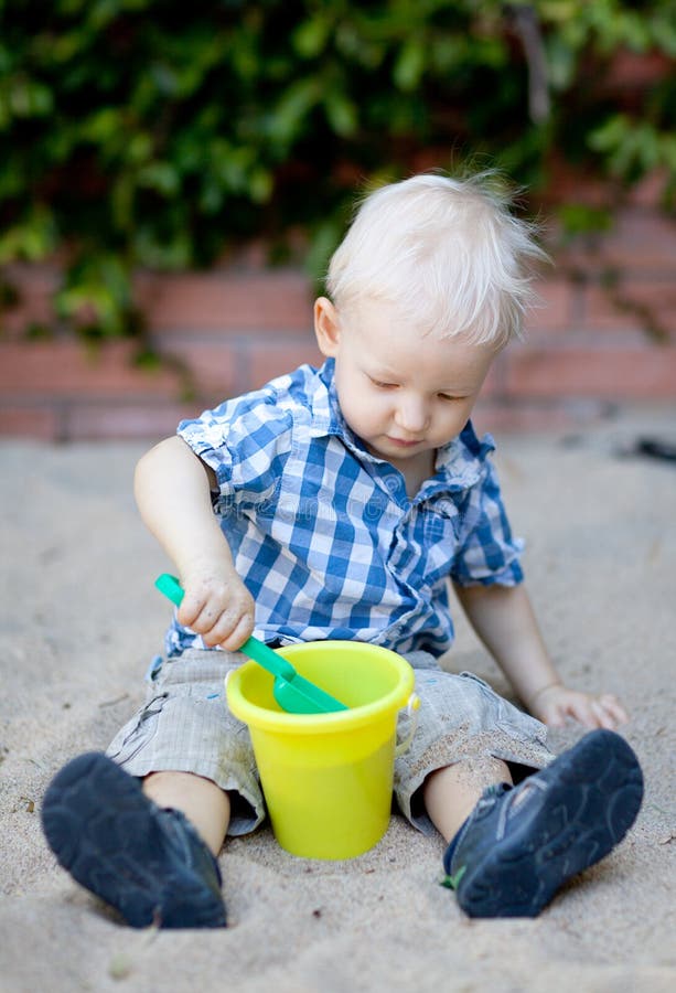 Toddler playing in sandbox stock image. Image of sunny - 19785259