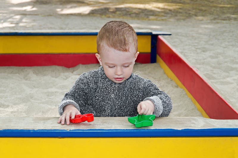 Toddler playing in sandbox stock image. Image of carefree - 156801087