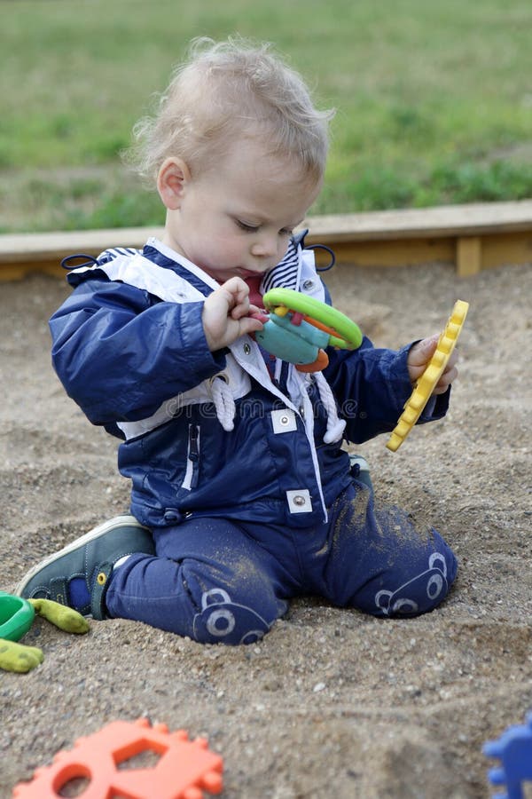Toddler playing in sandbox stock image. Image of discovery - 75261553