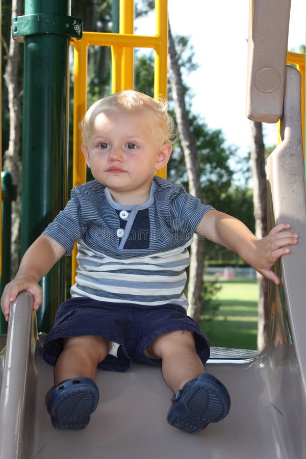 Toddler playing on a slide stock image. Image of happy - 56046147