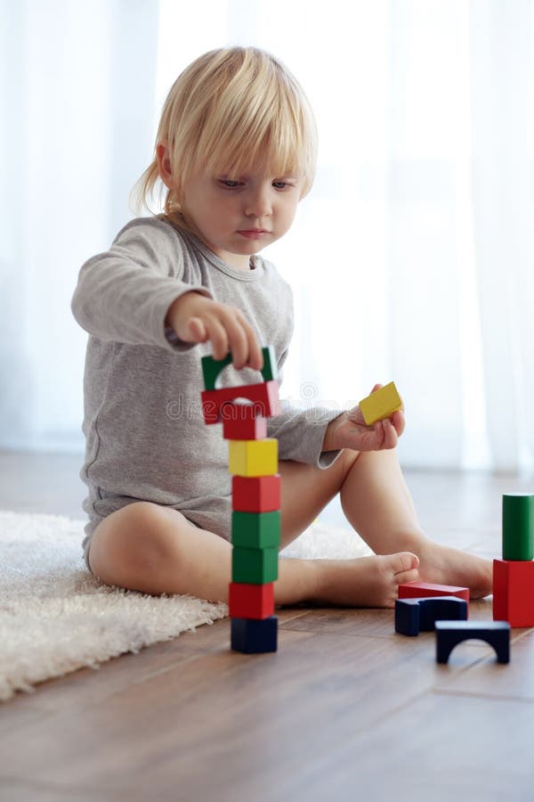 Toddler Playing with Wooden Blocks Stock Image - Image of diligent ...