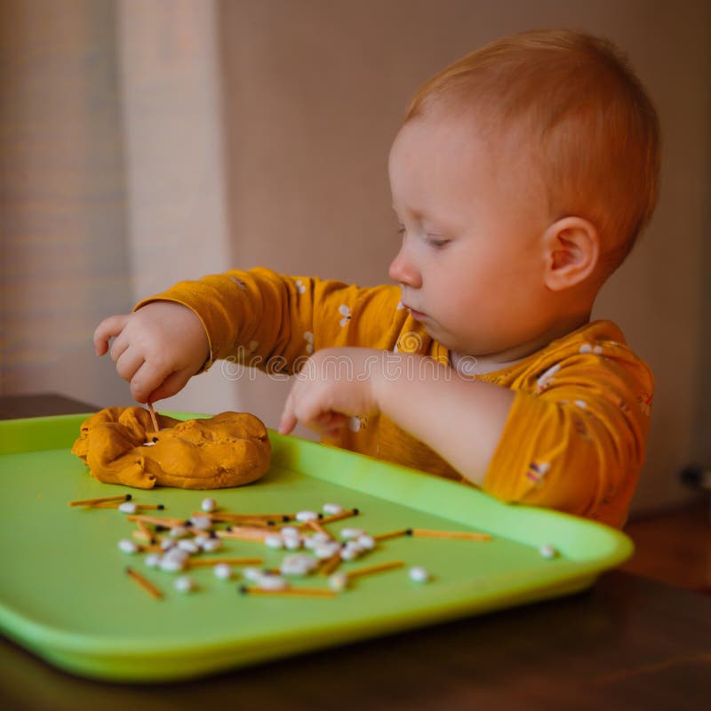 Toddler Plays with Modeling Dough with Small Objects. Stock Image ...