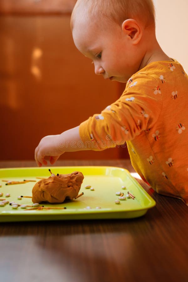Toddler Plays with Modeling Dough with Small Objects. Stock Photo ...