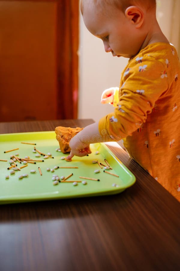 Toddler Plays with Modeling Dough with Small Objects. Stock Image ...