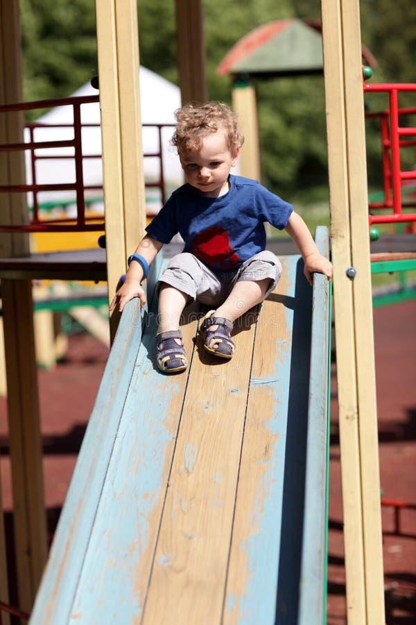 Toddler sliding on a slide stock image. Image of innocence - 32261541