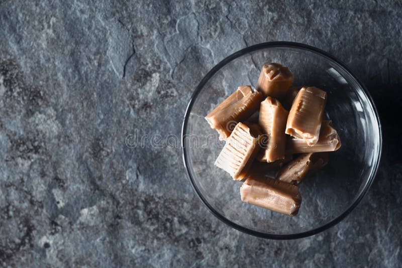 Toffee in the Glass Bowl on the Stone Table Top View Stock Photo ...
