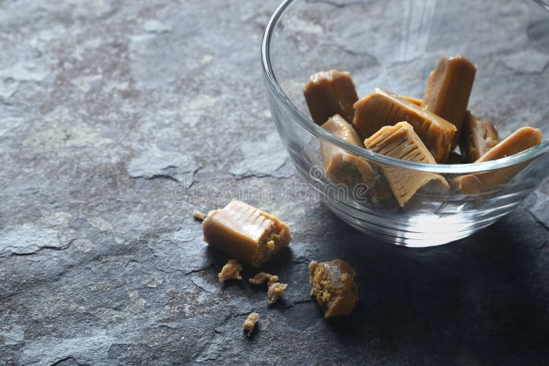 Toffee in the Glass Bowl on the Stone Table Stock Image - Image of ...