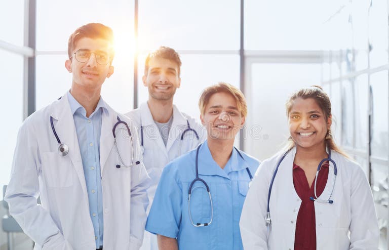 Professional Multinational Doctors Camera Posing. Teamwork Connection ...