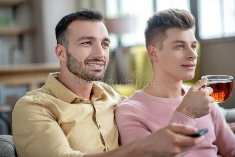 Two Young Men Having Tea and Watching Tv Together Stock Photo - Image ...