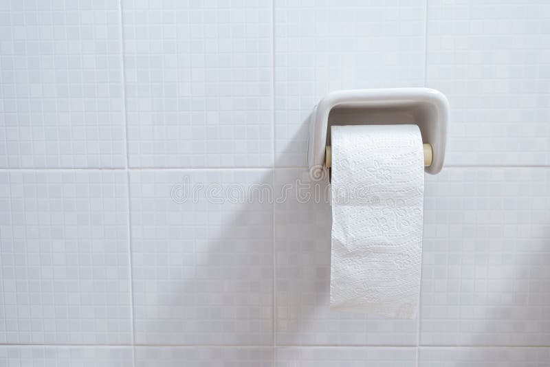 Toilet Tissue Roll Hanging on White Tile Wall Stock Image - Image of ...