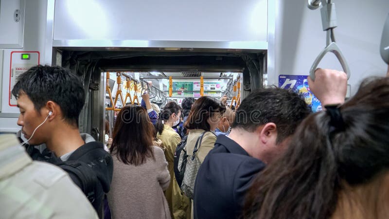 TOKYO, JAPAN - APRIL, 18, 2018: Interior Shot of a Crowded Commuter ...