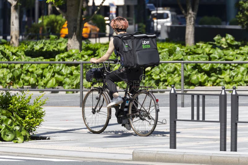 Uber Eats driver in Tokyo editorial photo. Image of adult - 212595726