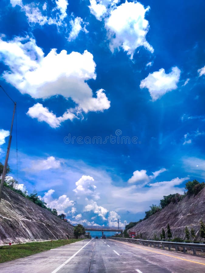 Toll Road Crossing Mount and Blue Sky in Background Stock Photo - Image ...