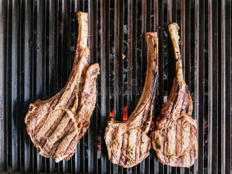 Tomahawk Rib Beef Steak on Hot Black Grill with Flames Stock Image ...