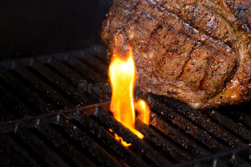 Tomahawk Steak on a Grill Grid on Fire Stock Photo - Image of meal ...
