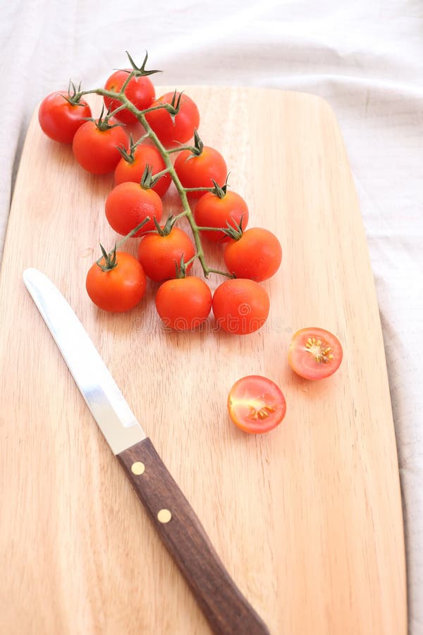 Tomato on Chopping Block with Knife Stock Photo - Image of background ...