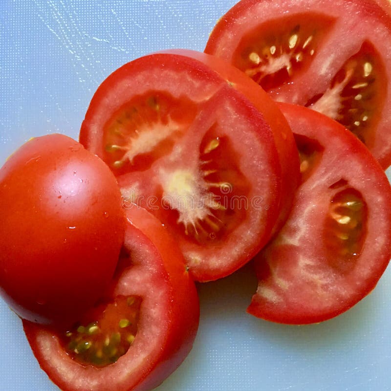 Tomato on chopping board stock image. Image of background - 153747189