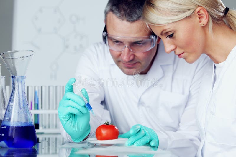 Researcher Holding Up a DNA Strand in the Lab Stock Photo - Image of ...