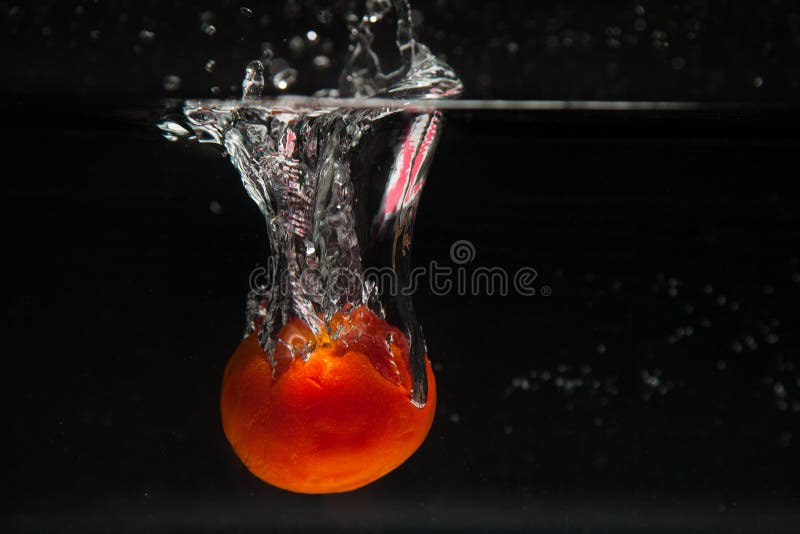 Red Tomato Falling Down in Glass with Water Stock Image - Image of ...