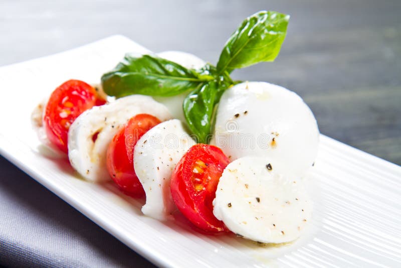Tomato and Mozzarella with Basil Leaves Stock Photo - Image of ...