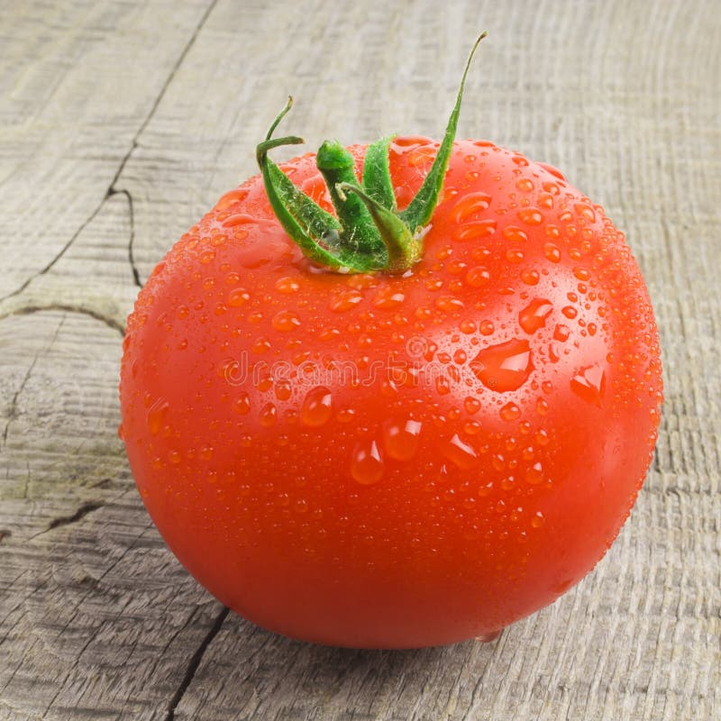 Tomato on old wooden table stock photo. Image of dinner - 28255440