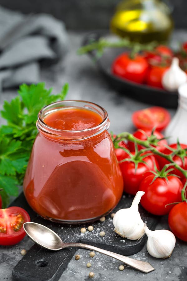 Tomato Paste, Puree in Glass Jar and Fresh Tomatos on Dark Background ...