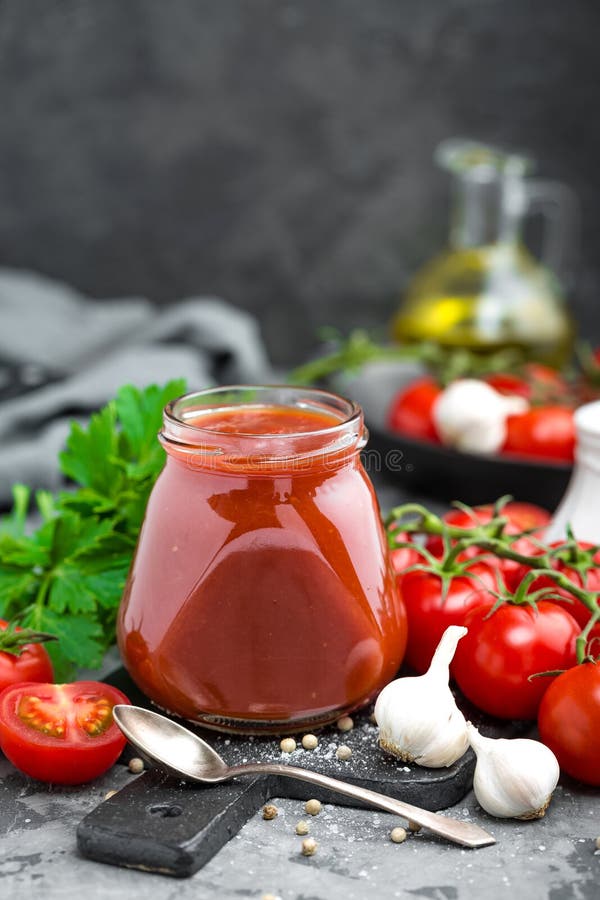 Tomato Paste, Puree in Glass Jar and Fresh Tomatos on Dark Background ...