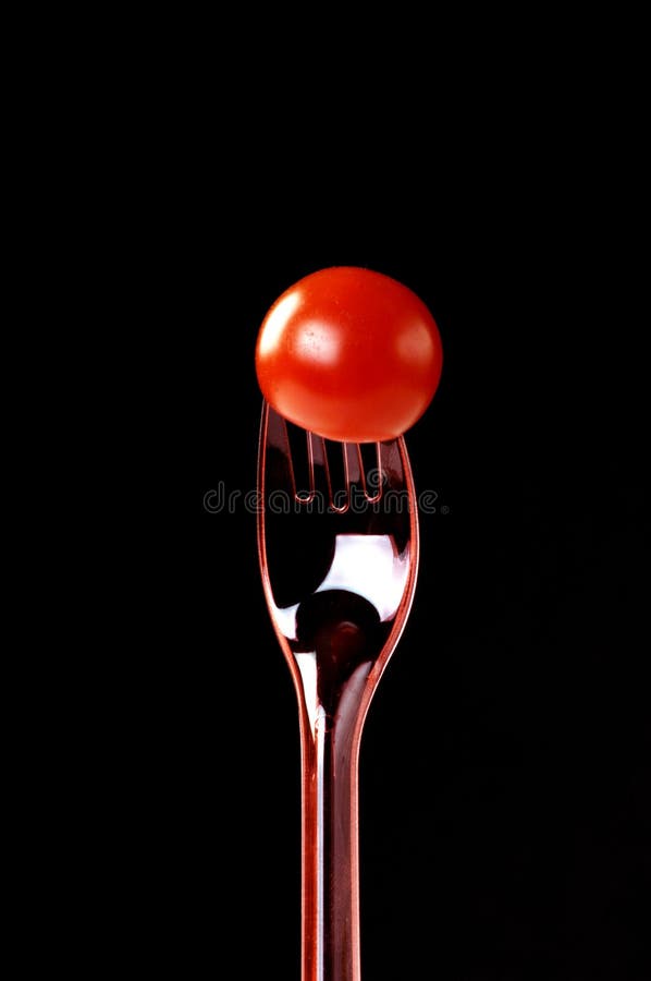 Tomato on red fork stock image. Image of forks, yellow - 5525823