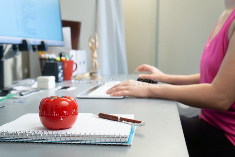 Tomato-shaped Kitchen Timer on a Working Desk - Time Management Concept ...
