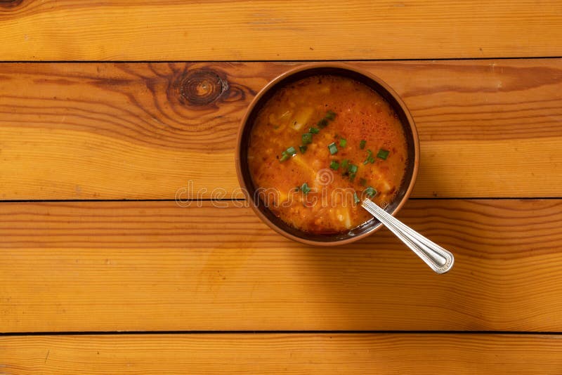 Tomato Soup Stands on a Wooden Board and Bread on a Wooden Table Stock ...