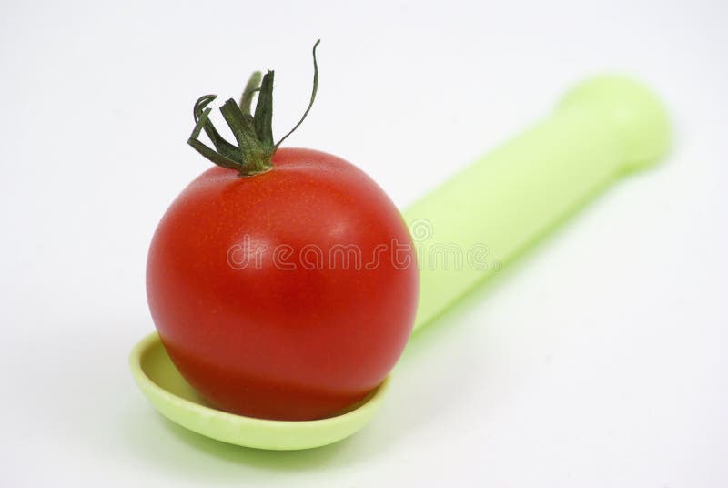 Tomato on the spoon stock image. Image of garden, organic - 11830855