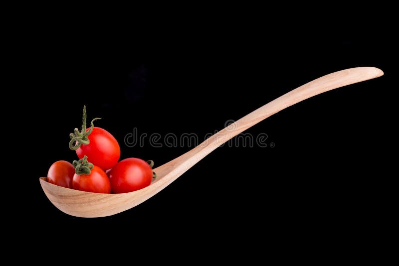 Tomato on spoon isolated stock photo. Image of background - 50196558