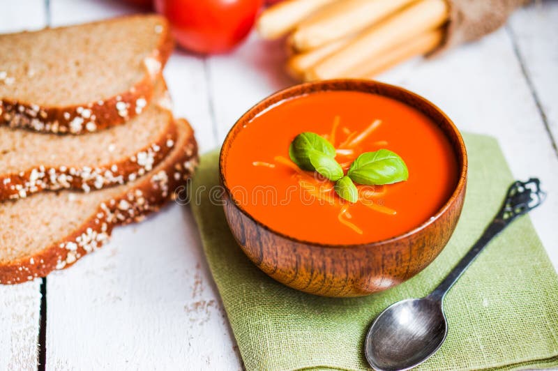 Tomatoe Soup with Bread Sticks and Basil on Wooden Background Stock ...