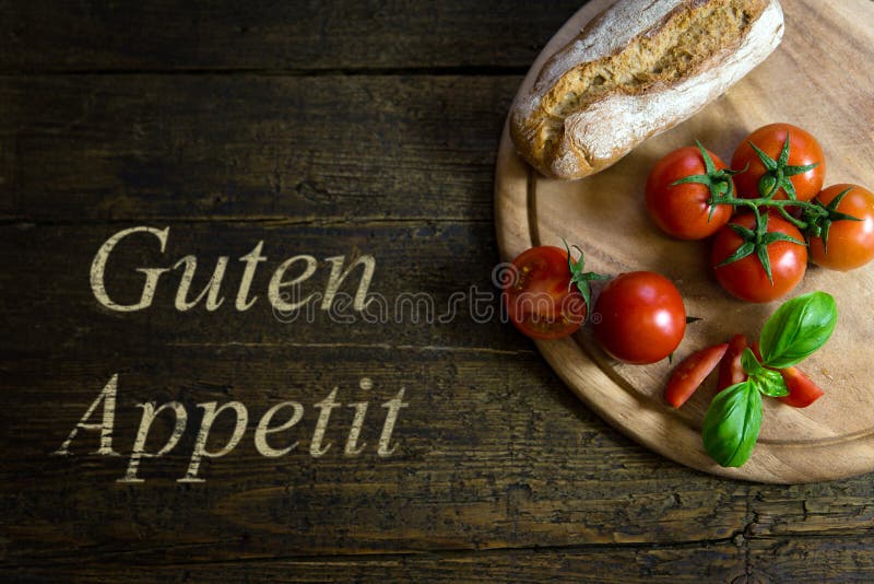 Tomatoes with Bread on Wooden Table, Text Guten Appetit Stock Photo ...