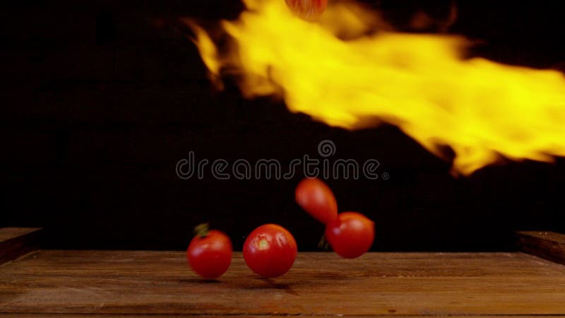 Tomatoes in Fire. Vegetables Throwing Falling through Fire Stock ...