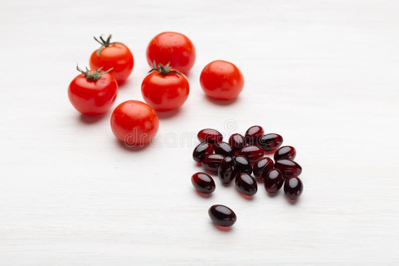 Tomatoes Lie on a White Table Next To Vitamins in the Form of Jelly on ...