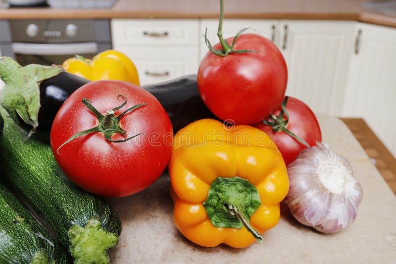 Tomatoes, Peppers and Courgettes Lying on the Table in the Kitchen ...