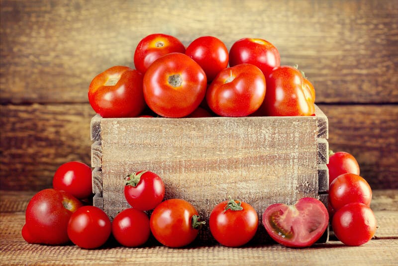 Tomatoes in a wooden box stock image. Image of organic - 56308721