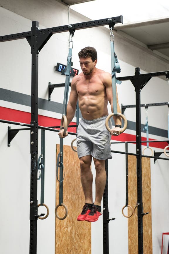 Toned Bodybuilder Exercising with Rings Stock Image - Image of muscular ...
