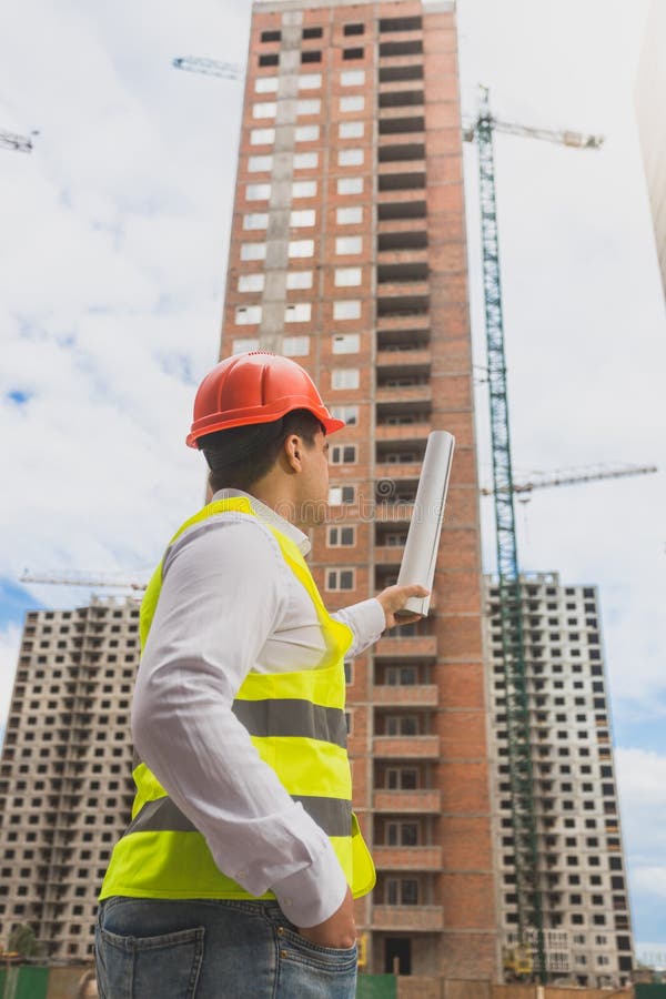 Toned Image of Architect Pointing at Building Under Construction Stock ...