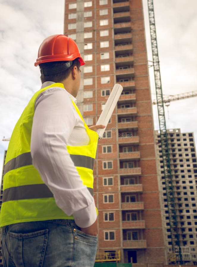 Toned Photo of Construction Engineer Pointing at Building Under Stock ...